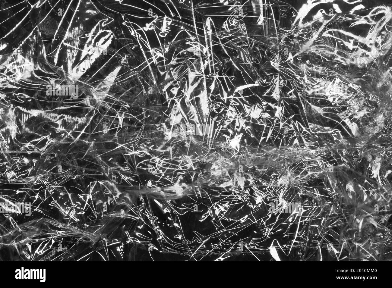 Reflecting light and shadow on creases and folds in scrunched clear ...