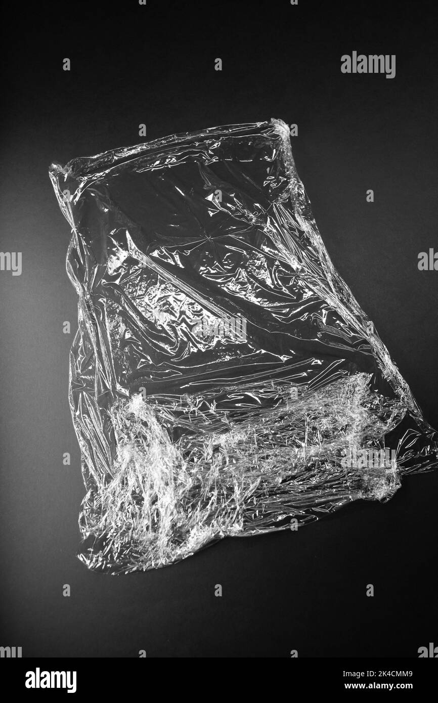 Reflecting light and shadow on creases and folds in scrunched clear ...