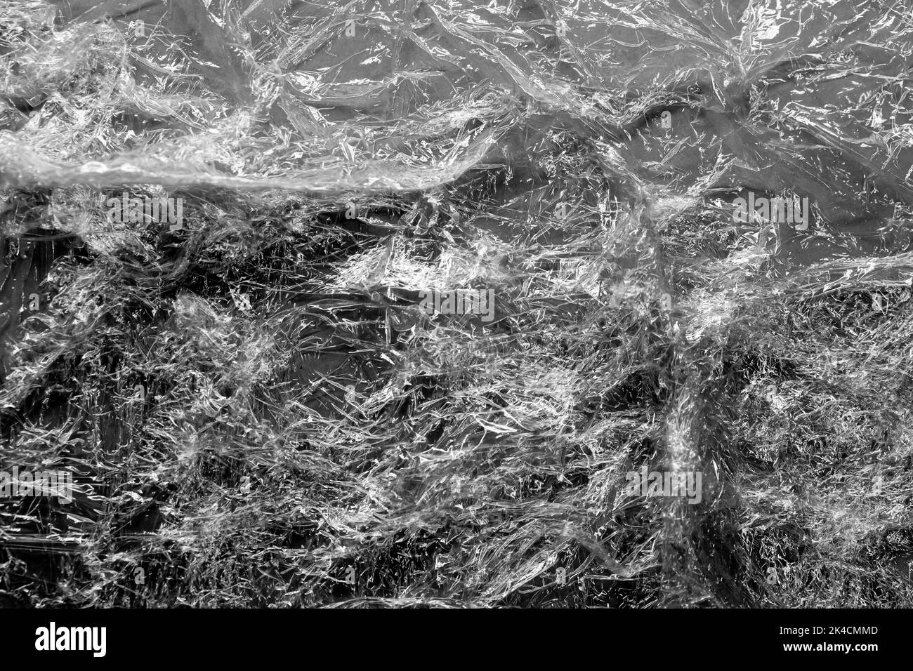 Reflecting light and shadow on creases and folds in scrunched clear ...