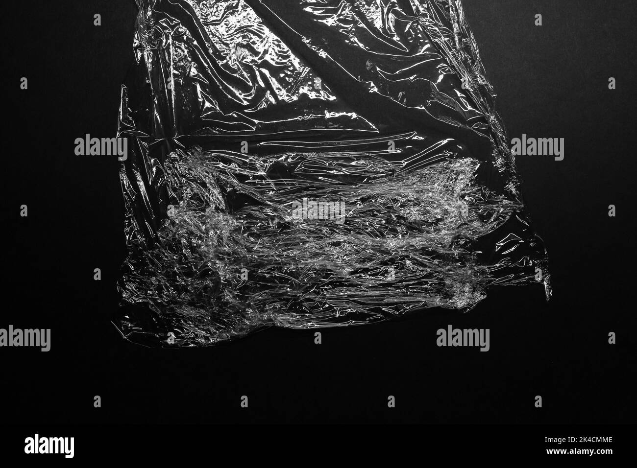 Reflecting light and shadow on creases and folds in scrunched clear ...