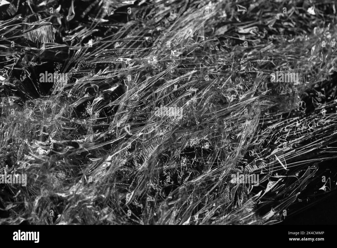 Reflecting light and shadow on creases and folds in scrunched clear ...