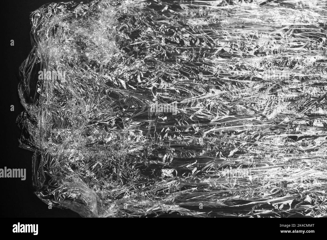Reflecting light and shadow on creases and folds in scrunched clear ...