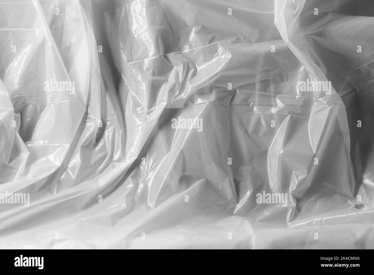 Reflecting light and shadow on creases and folds in scrunched white ...