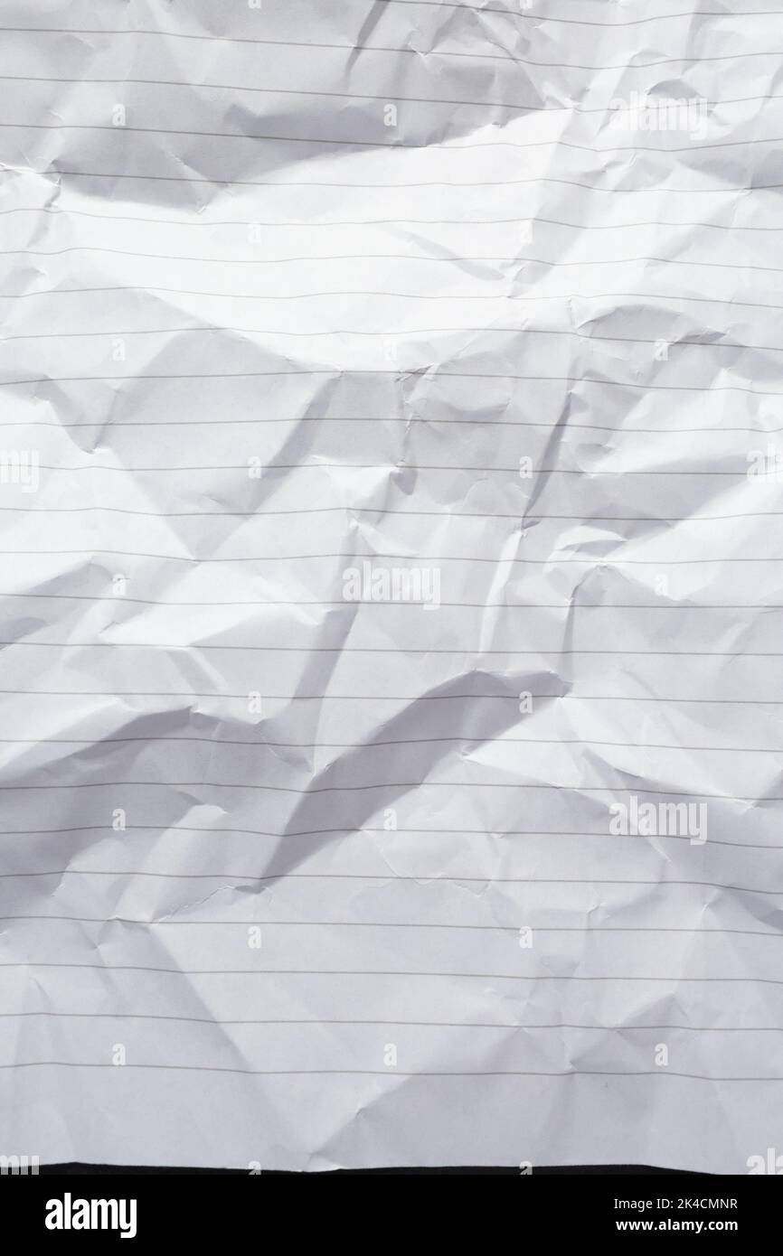 Light and shadow on creased sheet of lined writing paper. monochrome ...