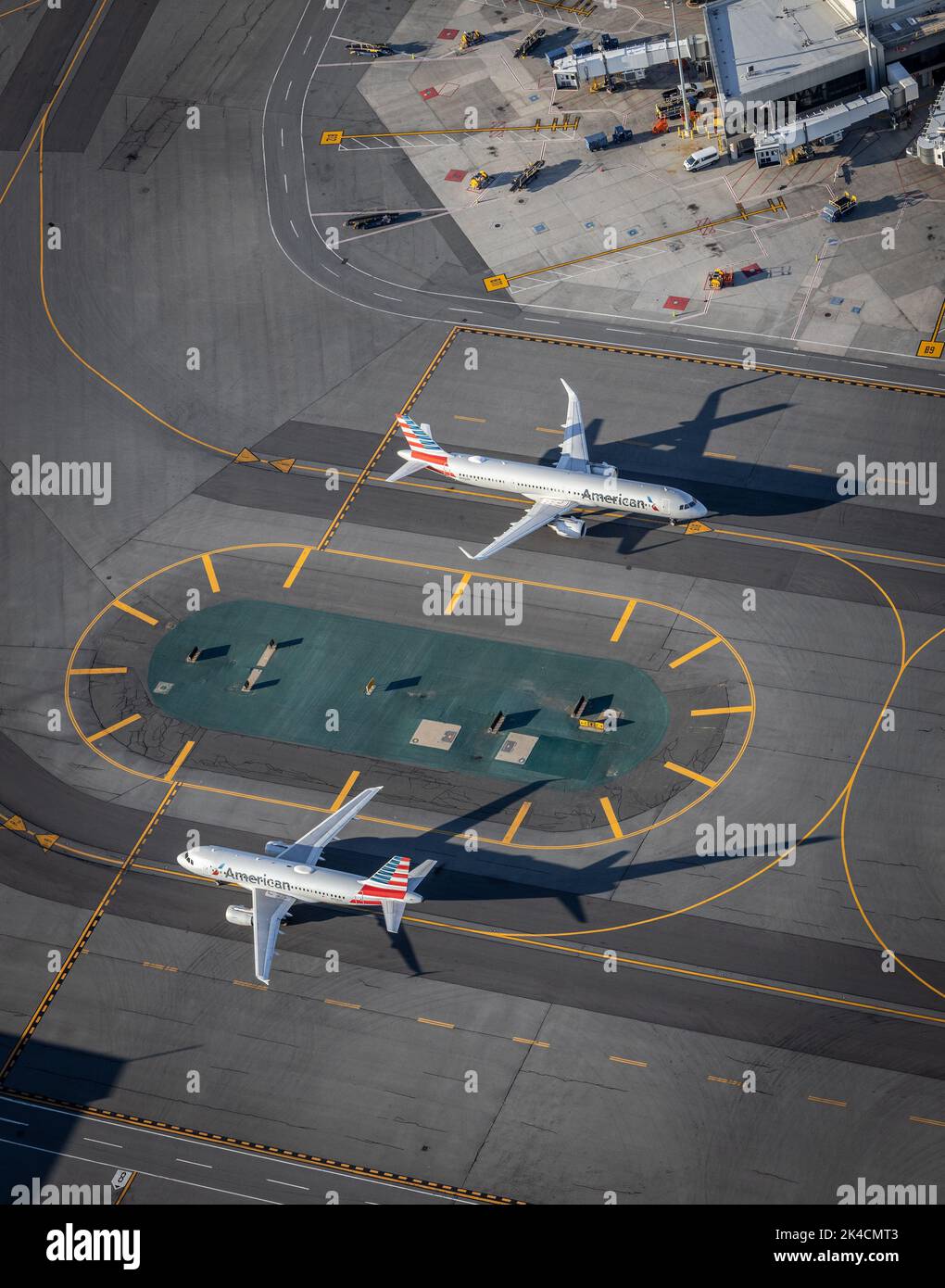 A vertical aerial view of two American Airlines planes taxing at Boston ...