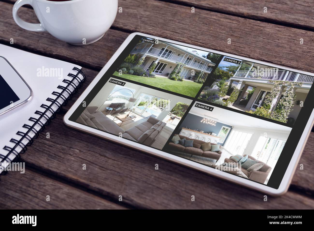 Tablet with views of home from security cameras on screen lying on ...