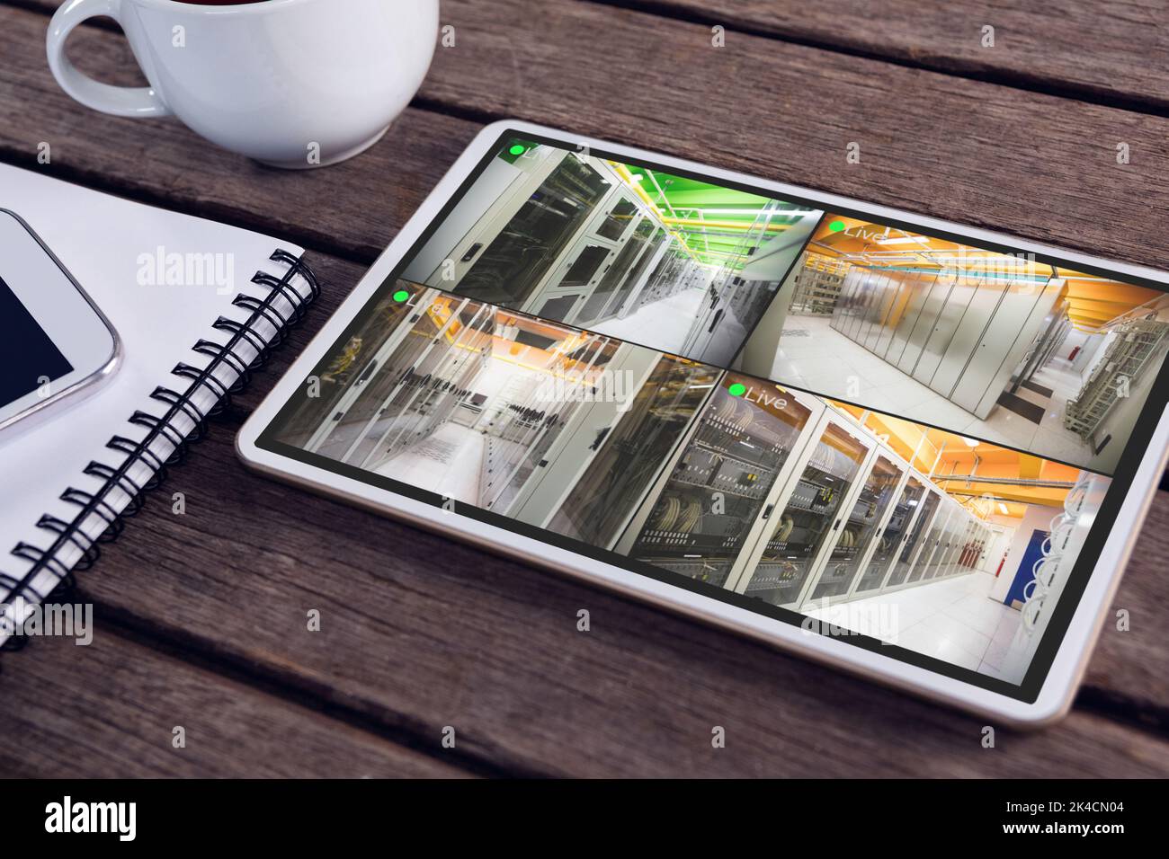 Hands of caucasian woman holding tablet with views of server rooms from ...