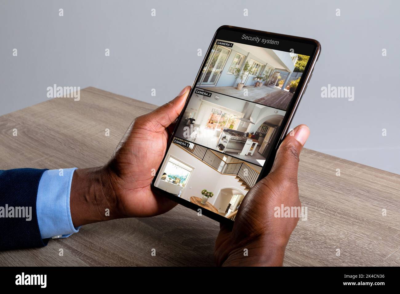 Hands of african american man holding tablet with view of home from ...