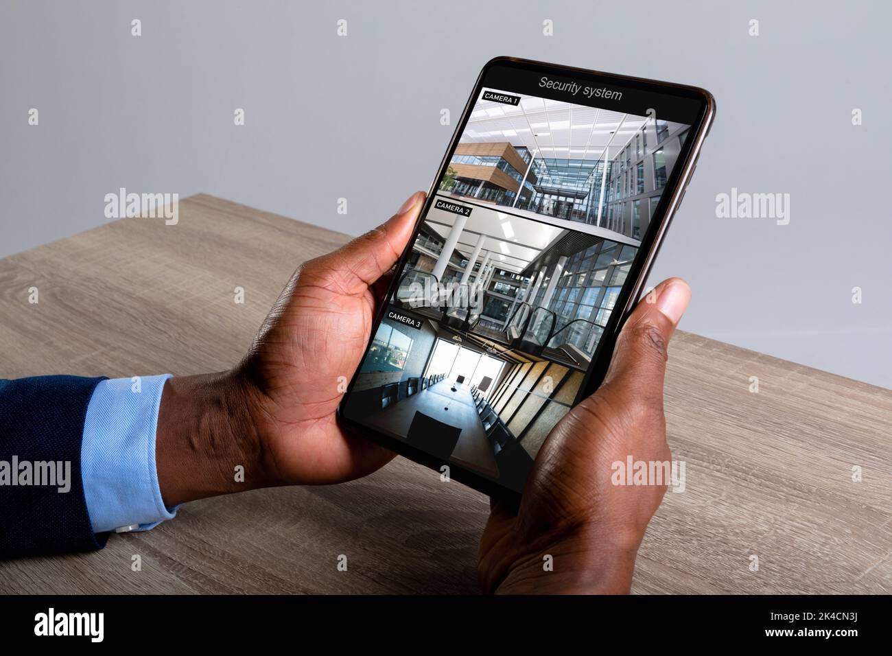Hands of african american man holding tablet with views of offices from ...