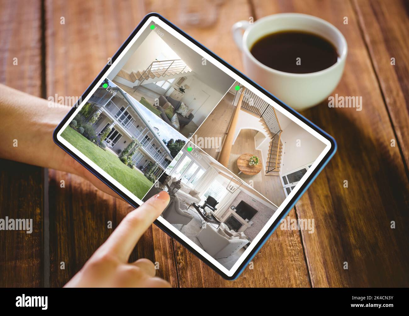 Woman using her tablet pc on wooden table Stock Photo - Alamy