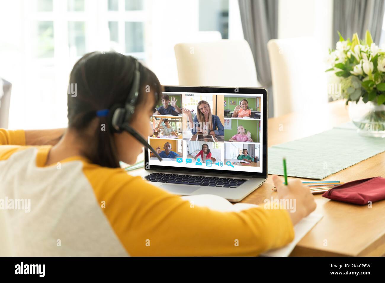 Asian girl using laptop for video call, with diverse elementary school ...