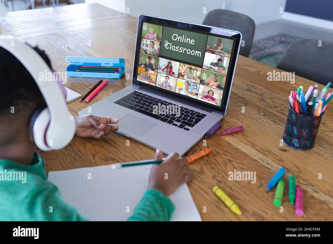 African american boy using laptop for video call, with diverse ...