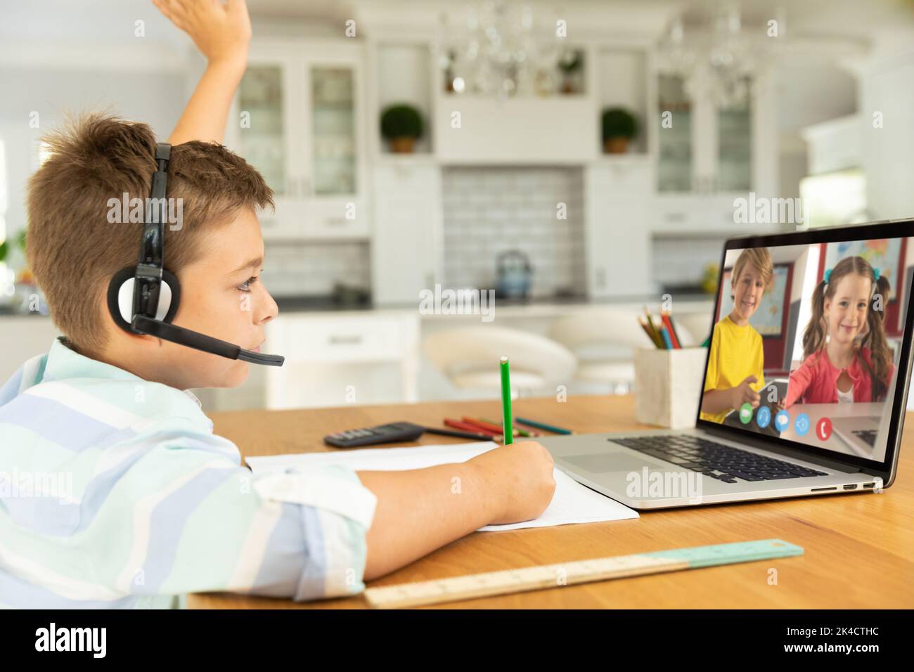 Caucasian boy raising hand for video call, with smiling caucasian ...