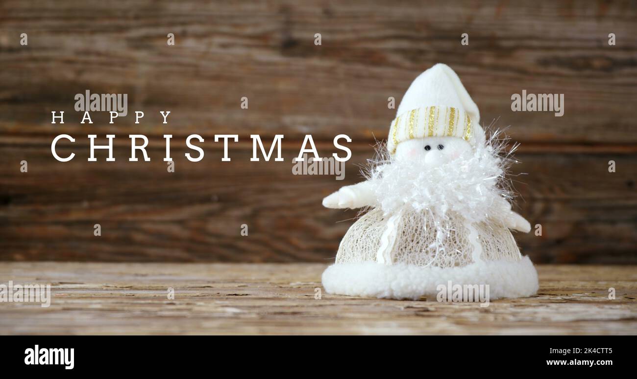 Composition of happy christmas text and santa claus on wooden ...