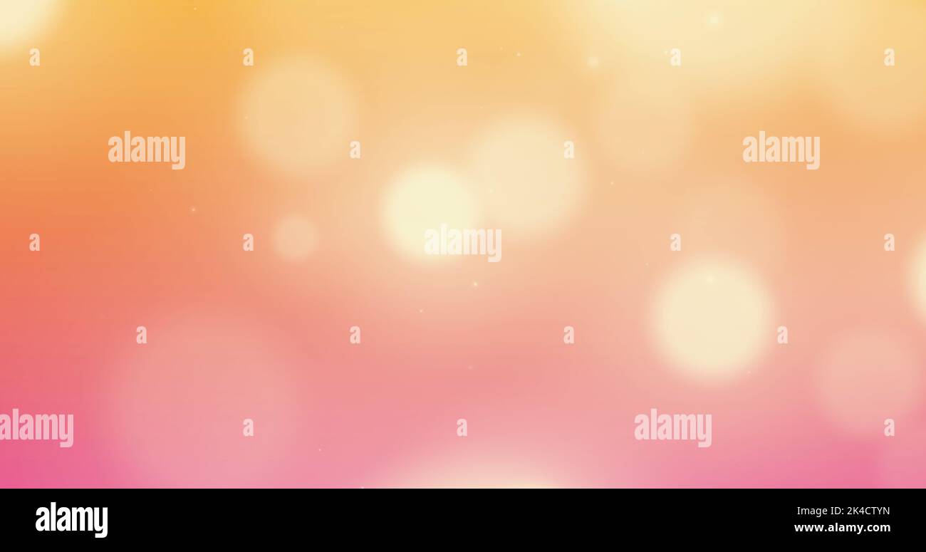 Image of defocussed yellow light spots on diffused orange and pink ...