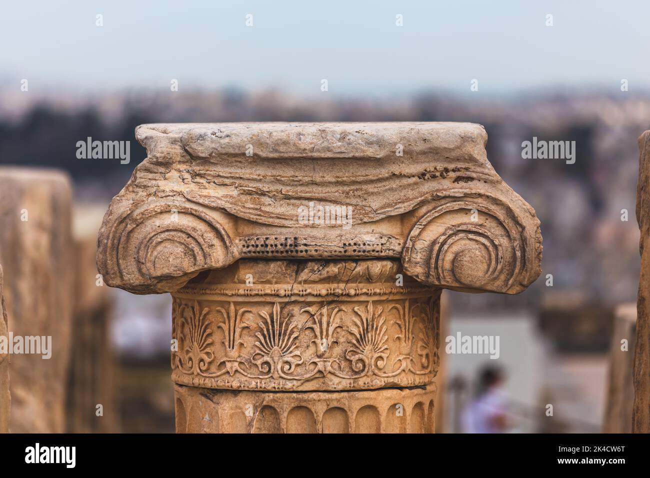 An ancient greek ionic order form column in Greece against a blurred ...