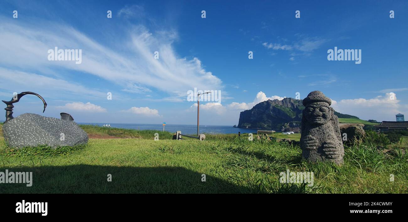 A panoramic view of a Dol hareubang rock statue on Jeju Island, South ...