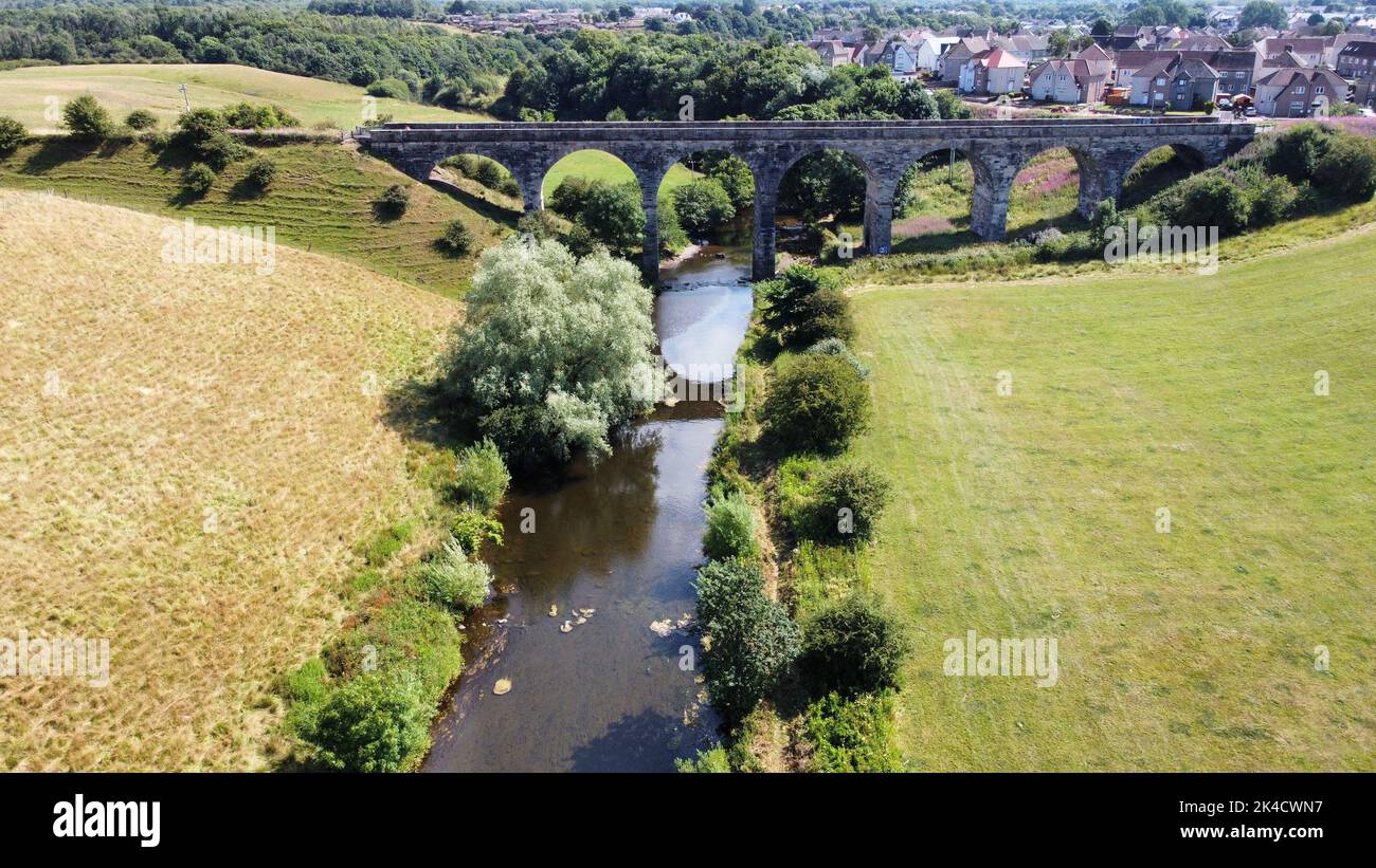 An aerial view over the Kilmacthomas Viaduct bridge on river and green ...