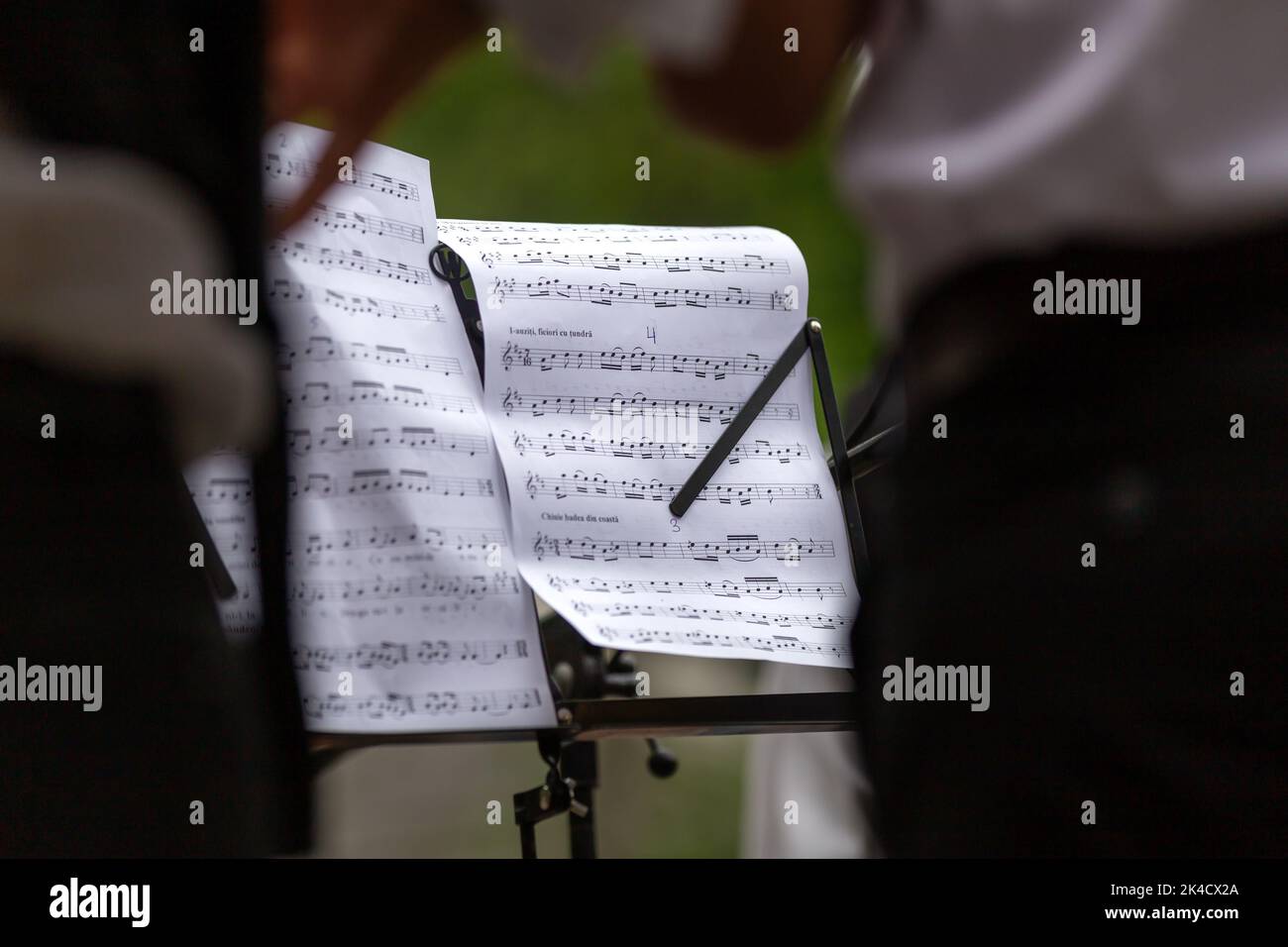 A close-up view of the sheets of music notes on the black stand Stock ...