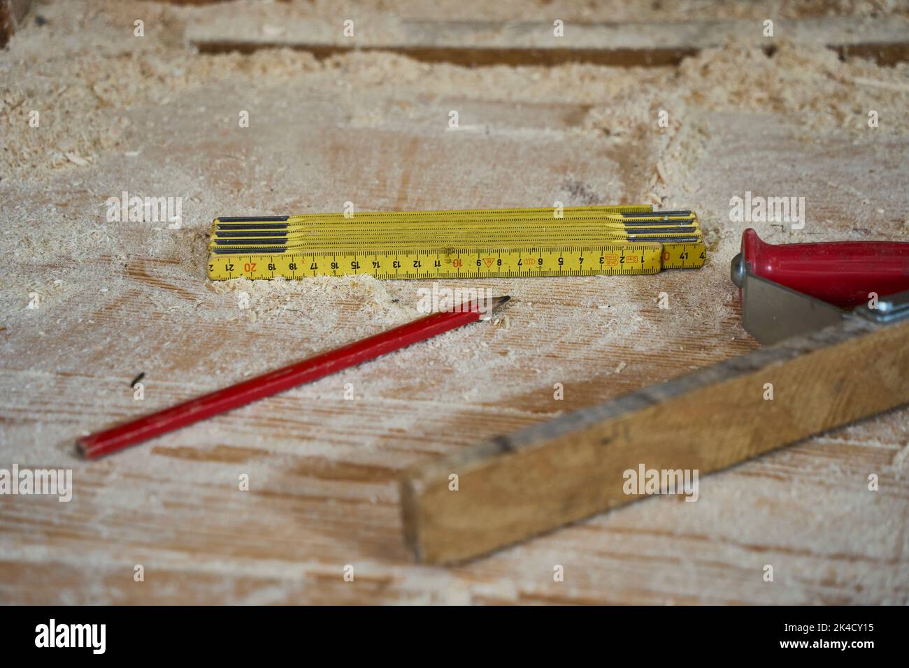 A closeup shot of industrial tools in the sawmill covered by sawdust ...