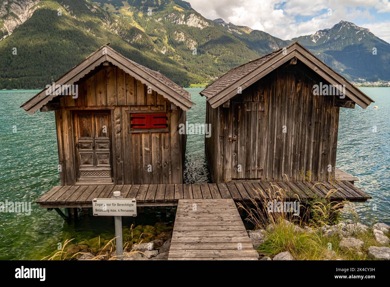 Two small wooden structures by the lake Stock Photo - Alamy