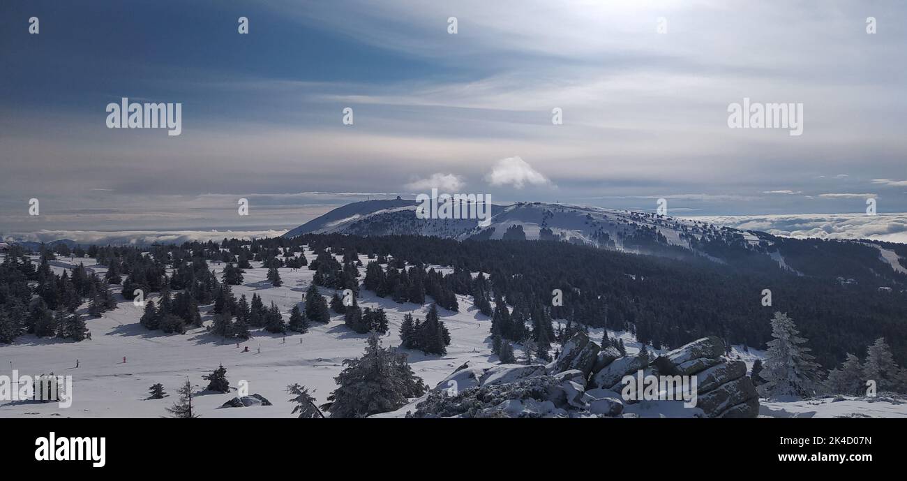 An aerial panoramic view of the snow-covered hills and forests in ...