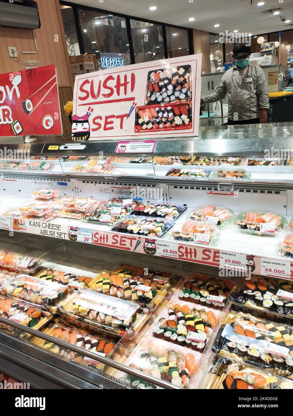 A vertical shot of sushi and other Japanese meals on display in a ...