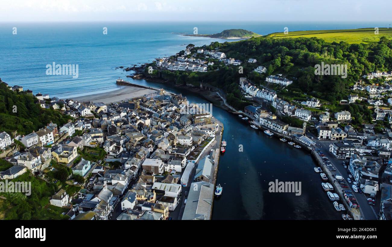 An aerial shot of the Looe Cornwall village on the coast of a beach ...