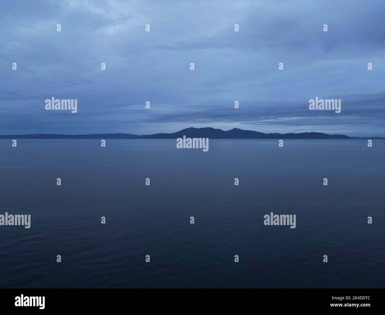 A beautiful scene of blue dramaric sky reflecting on calm blue oean ...