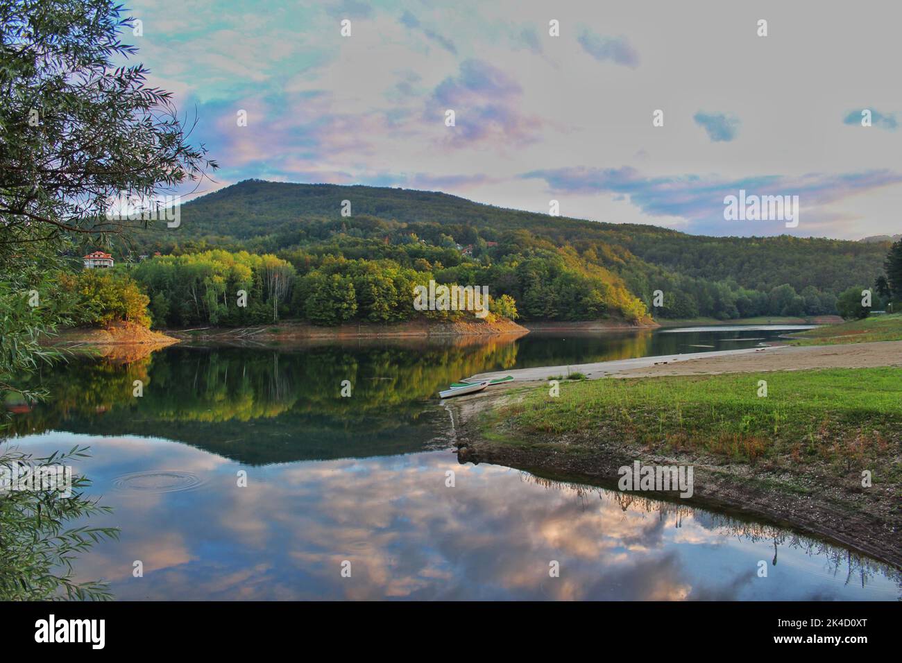 A beautiful natural scenery of a river flowing in a village surrounded ...