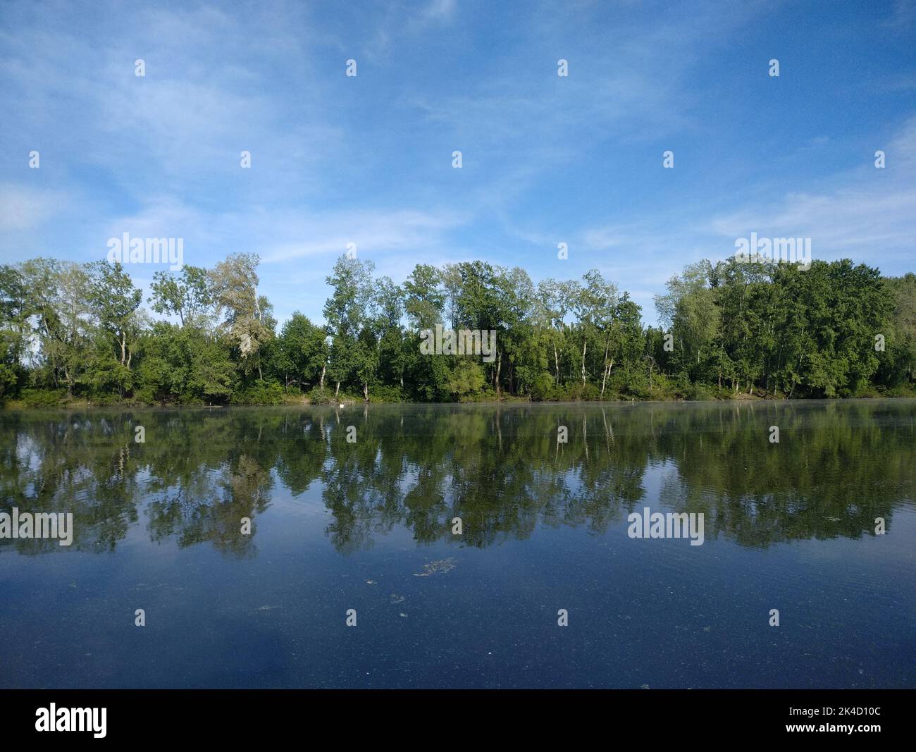 A beautiful natural scenery of a river flowing in a village surrounded ...