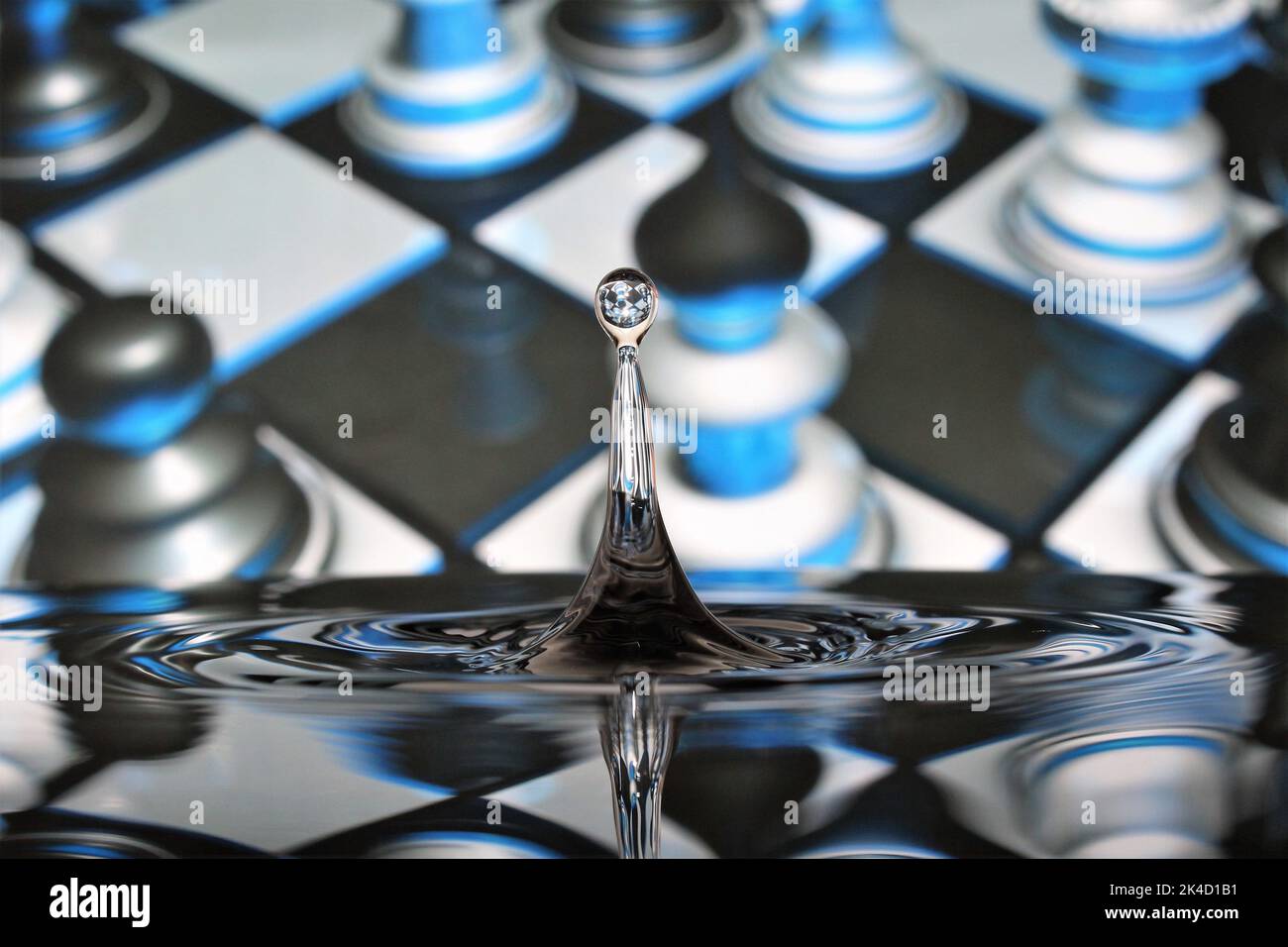 A water drop against a chess background Stock Photo - Alamy