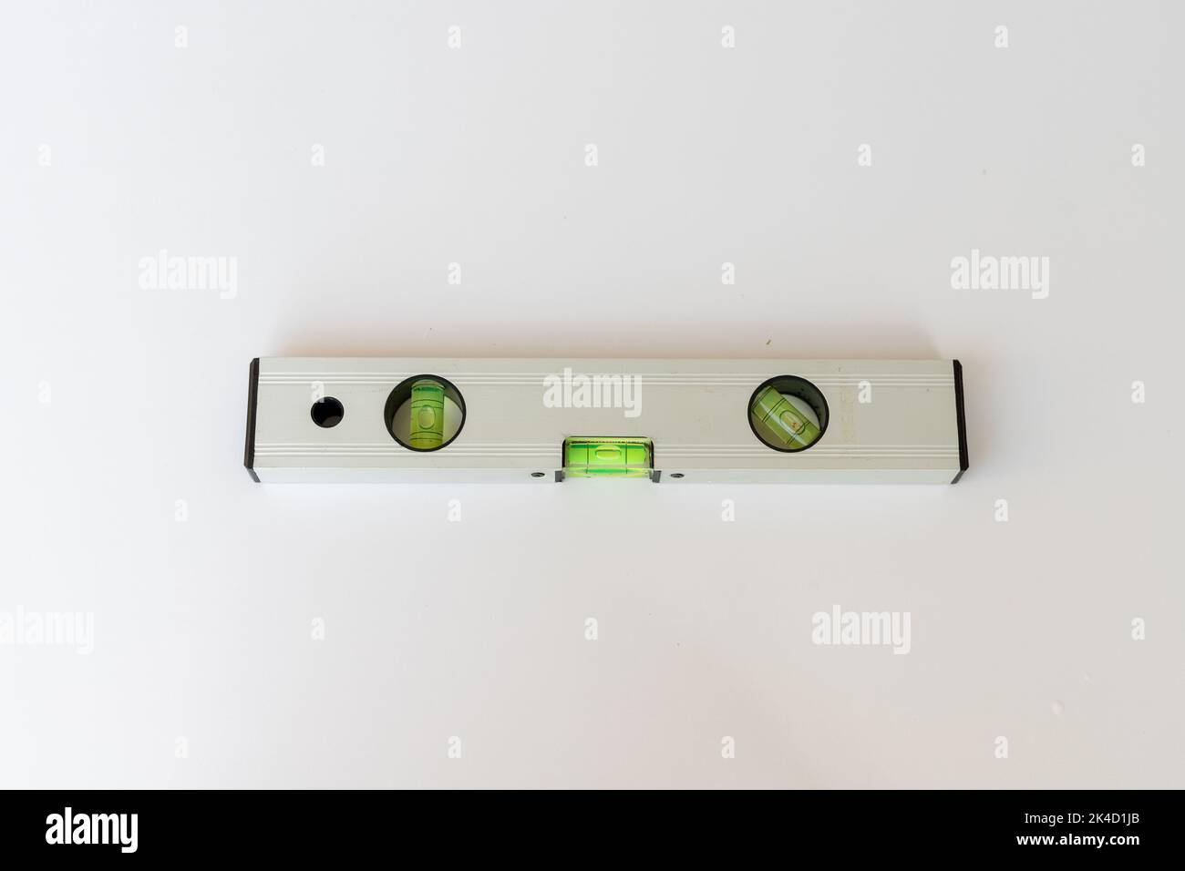 spirit leveling tool laying on a white isolated background Stock Photo ...