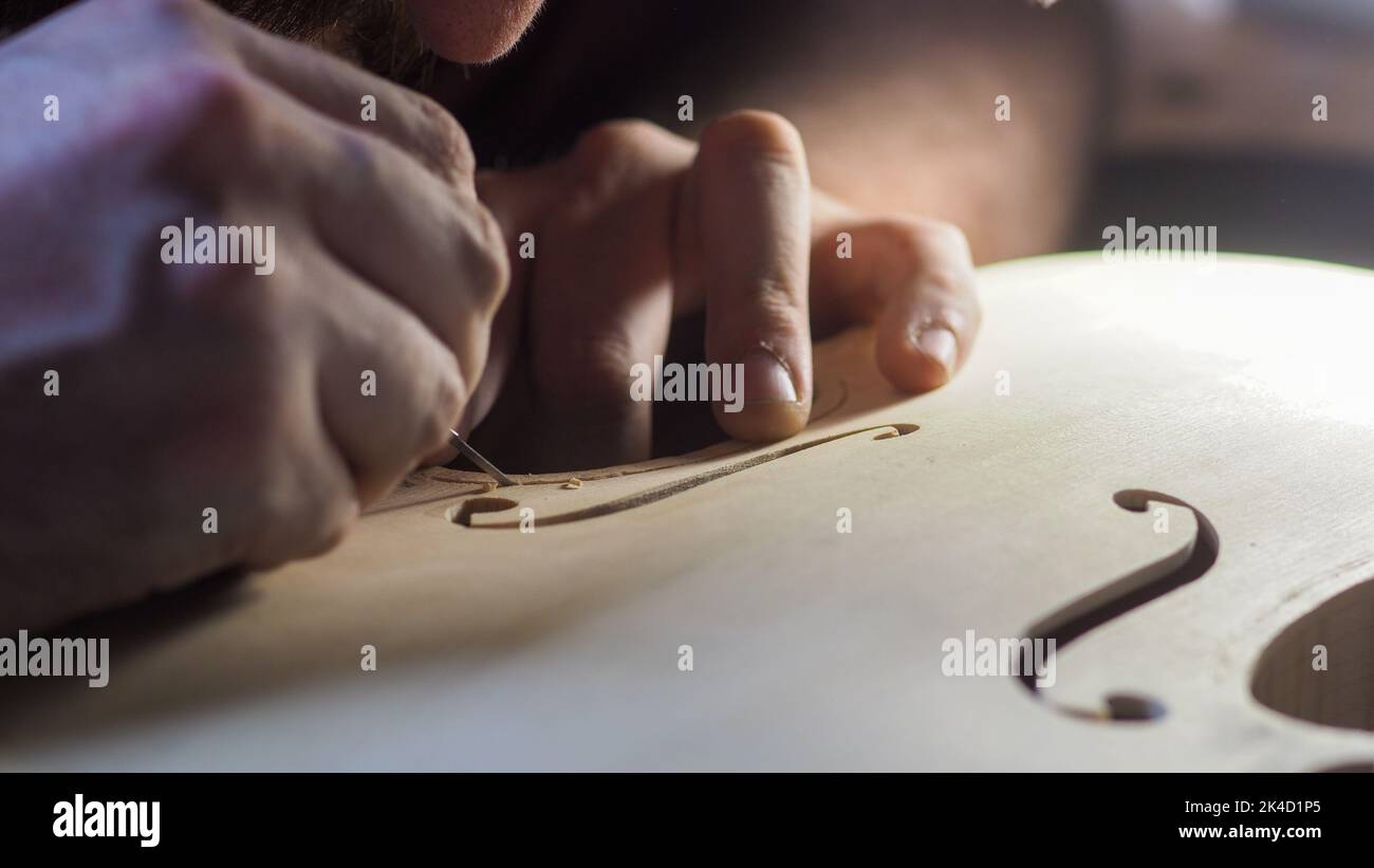 Close up of professional master artisan luthier painstaking detailed ...