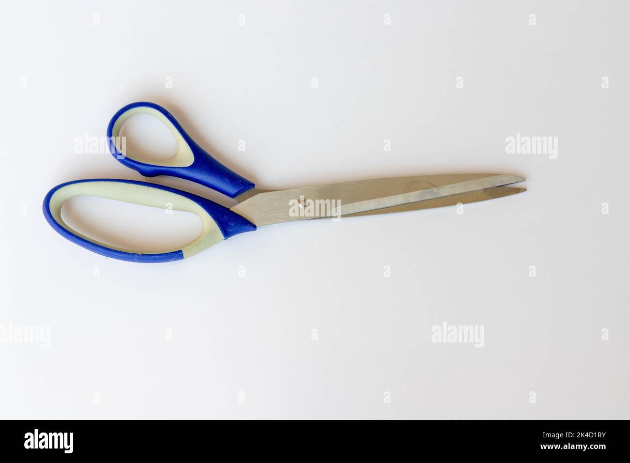 Stainless steel scissors with blue handles Stock Photo - Alamy