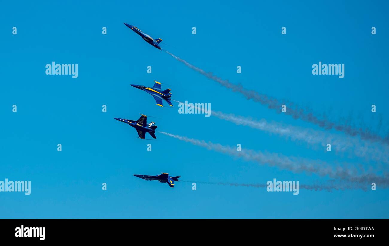 A formation of F-18 Super Hornet Blue Angel aircrafts in flight in a ...