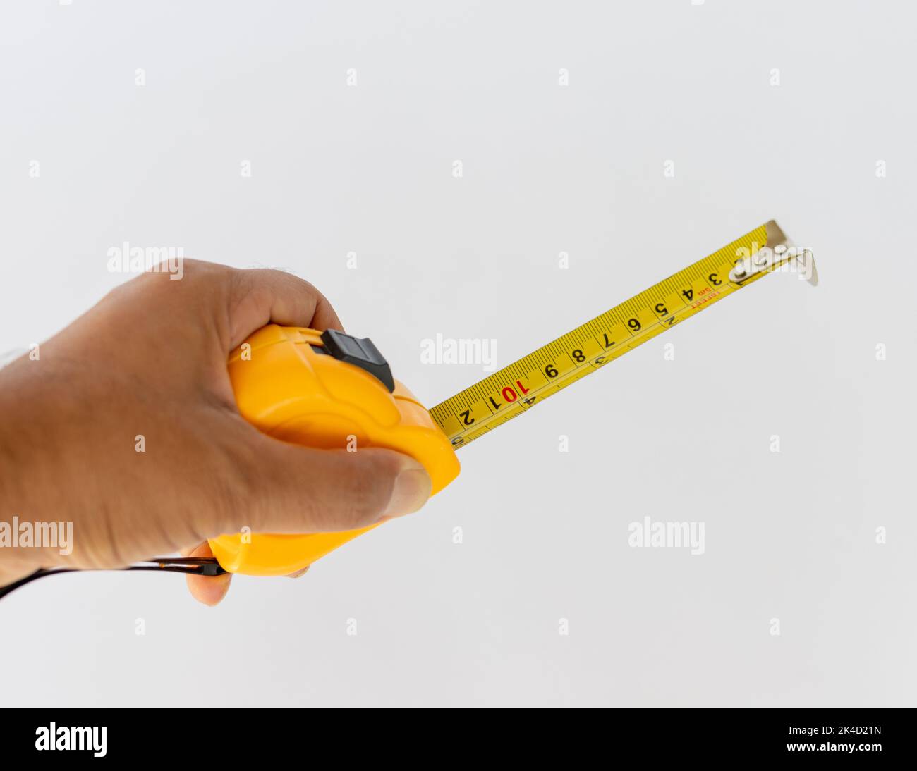 Measuring tape holding in hand on white isolated background Stock Photo ...