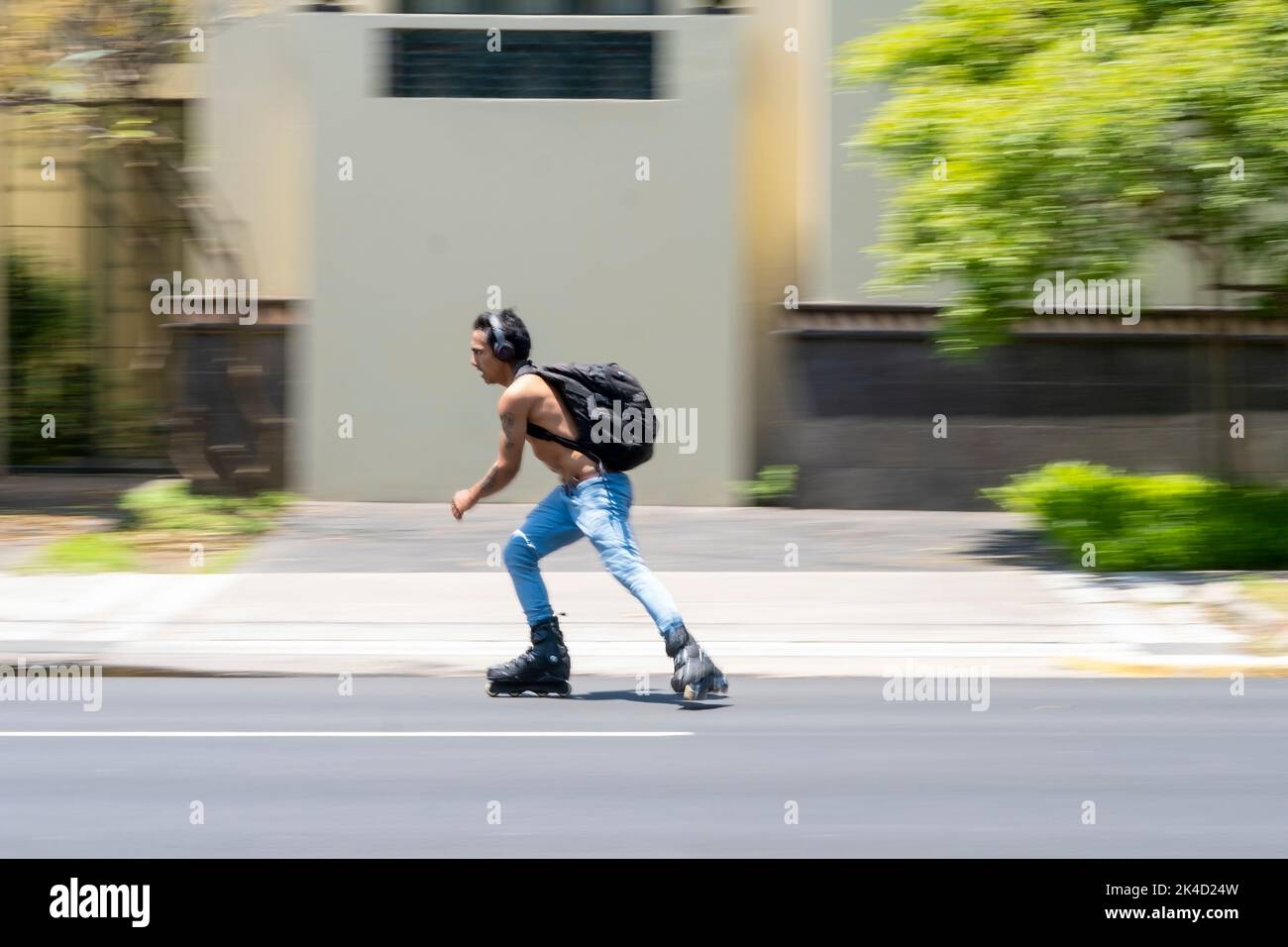 young man, person skating with skates, skating in the street, blurred ...