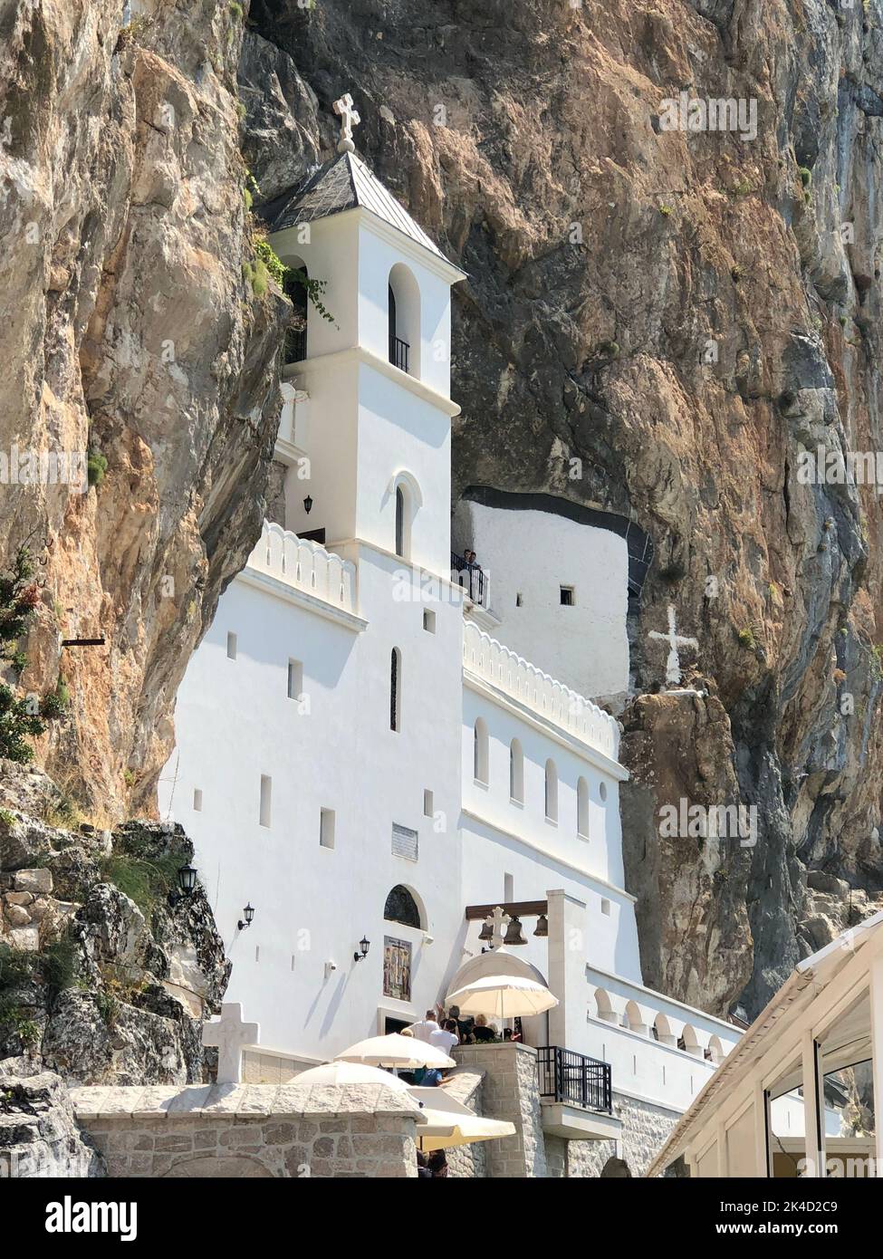 A vertical shot of the facade of the Ostrog monastery in Montenegro ...