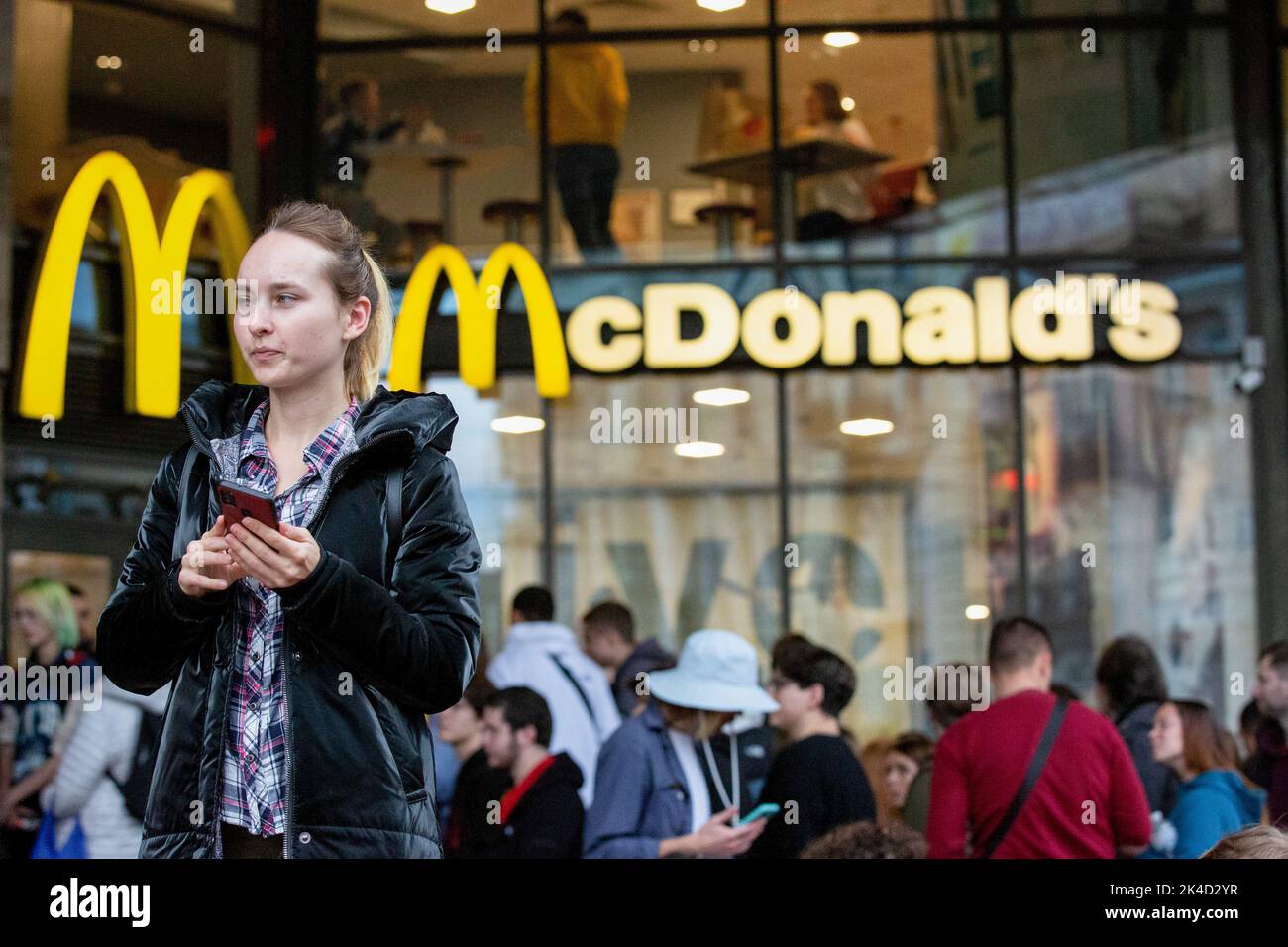 A girl waiting in line to pick up an order at the McDonald's restaurant ...