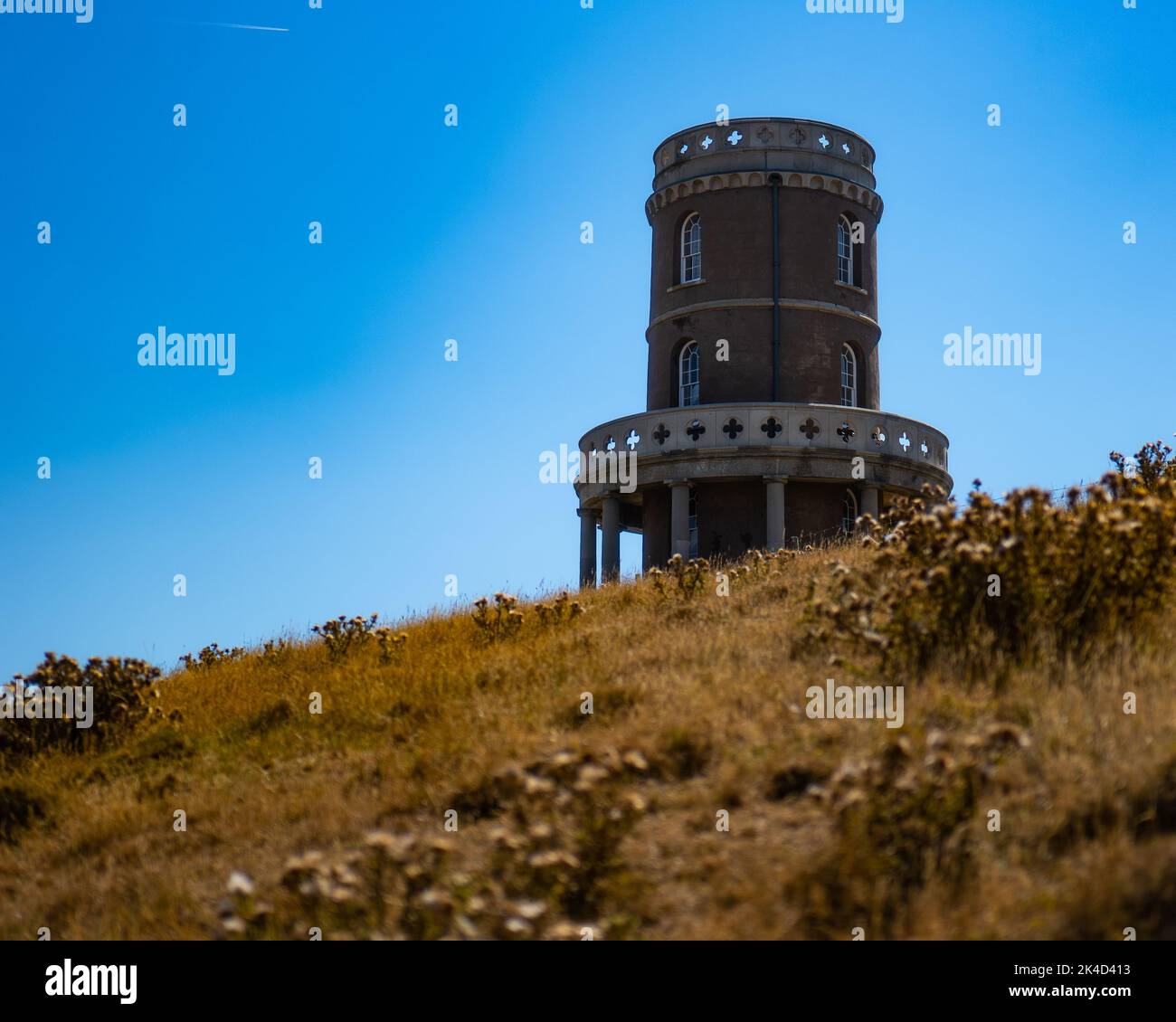 A beautiful view of the Clavell Tower in Kimmeridge, England with hills ...