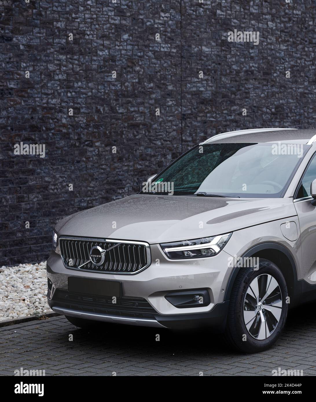 A vertical shot of a gray Volvo XC 40 parked on a paved street in ...
