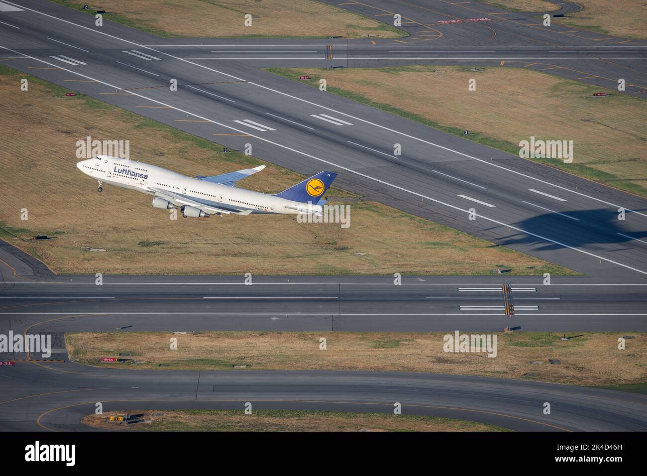 An airplane of Lufthansa Boeing 747 jet taking off from Logan International Airport in Boston ...