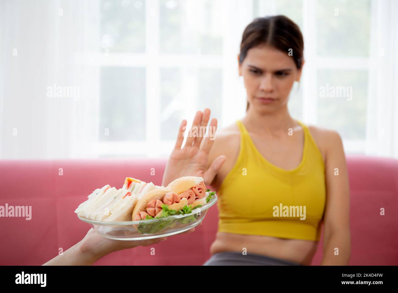 Hands serving food and young caucasian woman making sign say no food ...