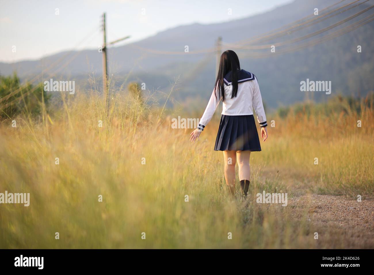 Asian High School Girls student walking in countryside with sunrise Stock Photo - Alamy