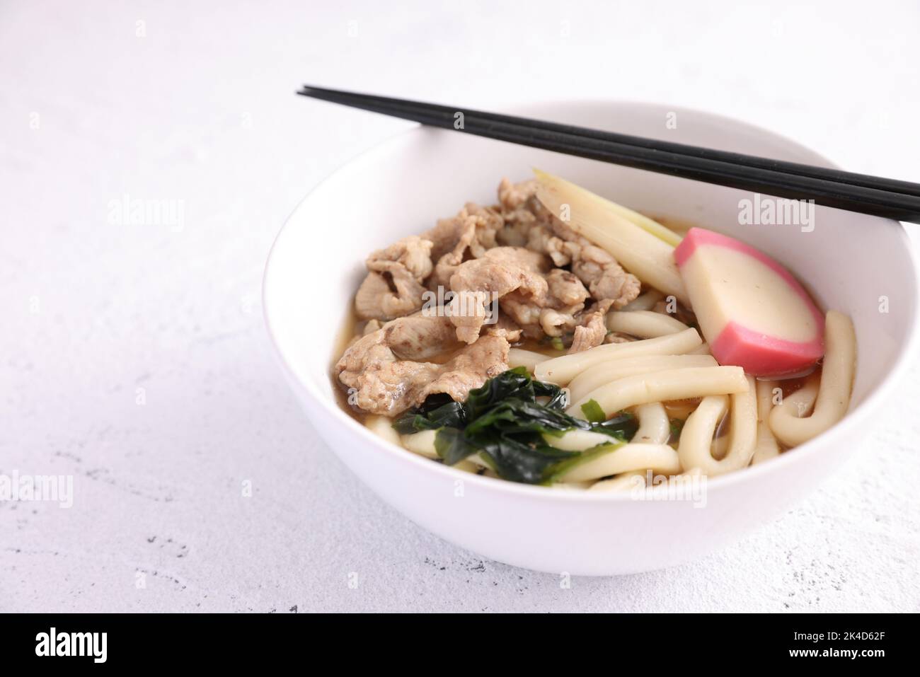 Udon noodles with pork isolated in white background Stock Photo - Alamy