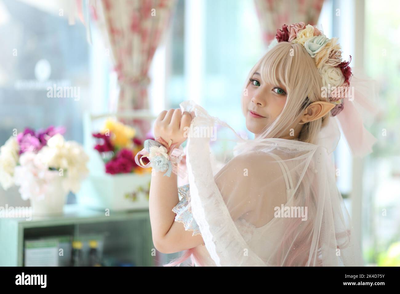 Beautiful young woman with white lolita dress with flowers garden ...