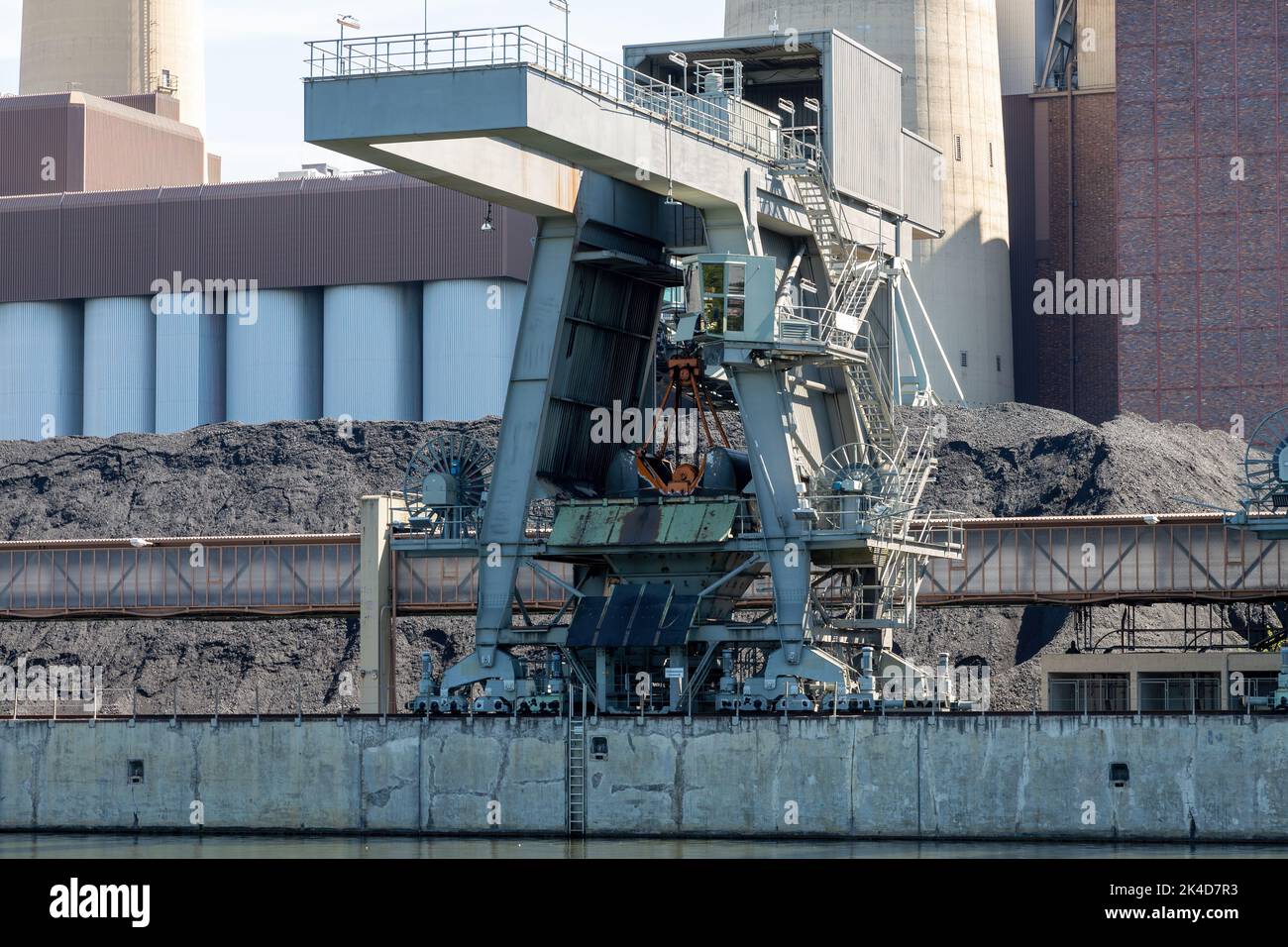 Coal crane with mountains of coal at coal power plant for electricity ...