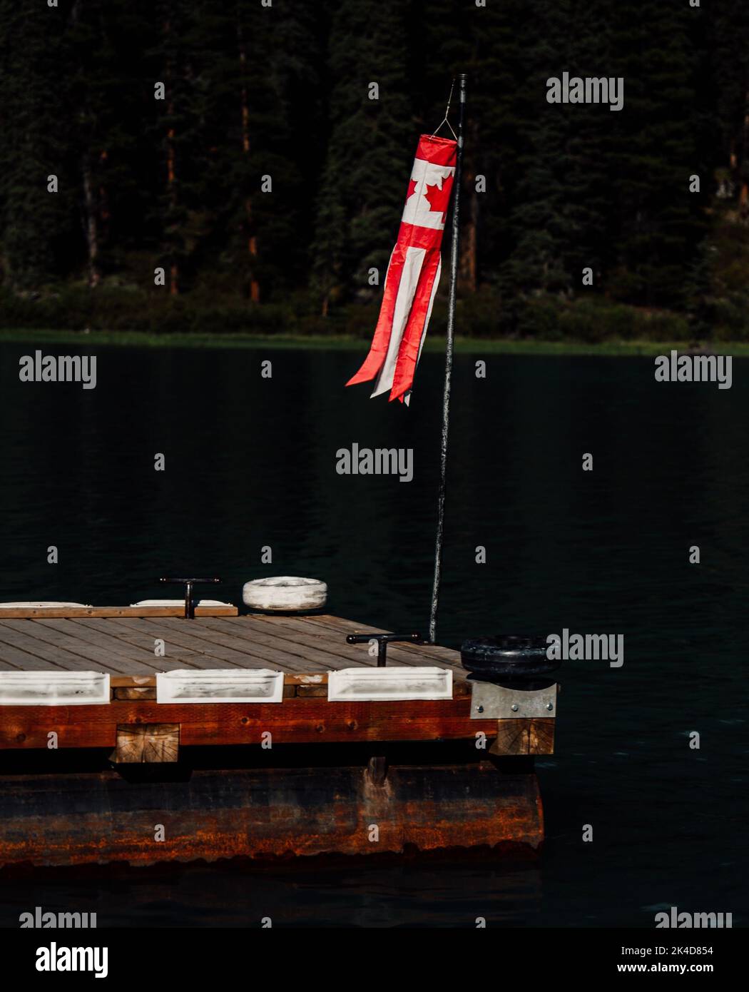 A vertical shot of a windsock with Canadian flag colors on a dock ...