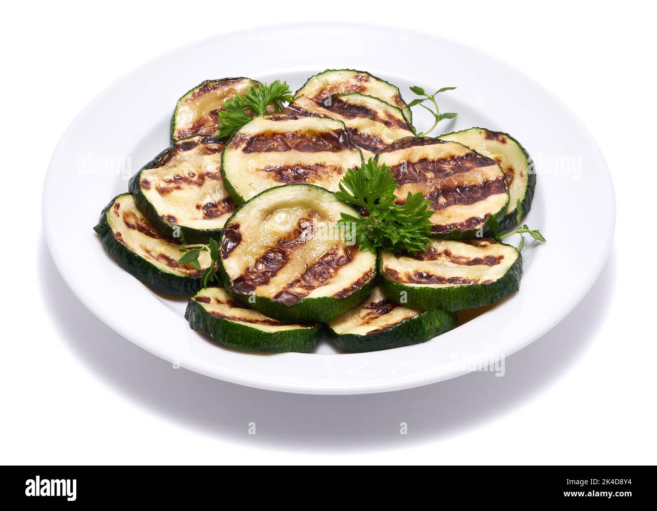 Slices of zucchini roasted on a grill with stripes from a grill ...